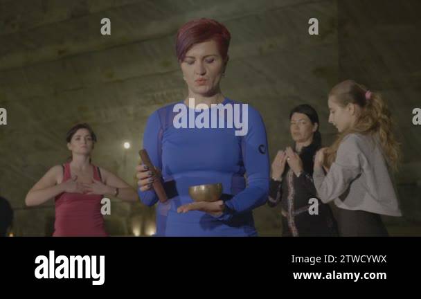 Female nirvana yoga instructor performing a breathing ritual with ...