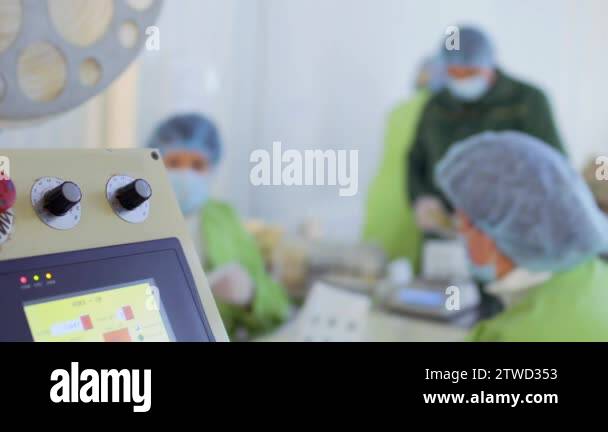 Screen of tea machine, people works at tea factory at blurred ...