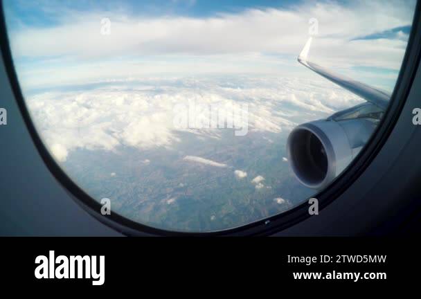 Airplane flying HIGH above the clouds. Inside view through the window ...