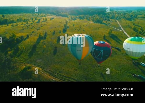 takeoff air balloon at sunset , air balloons start fly from grass field ...