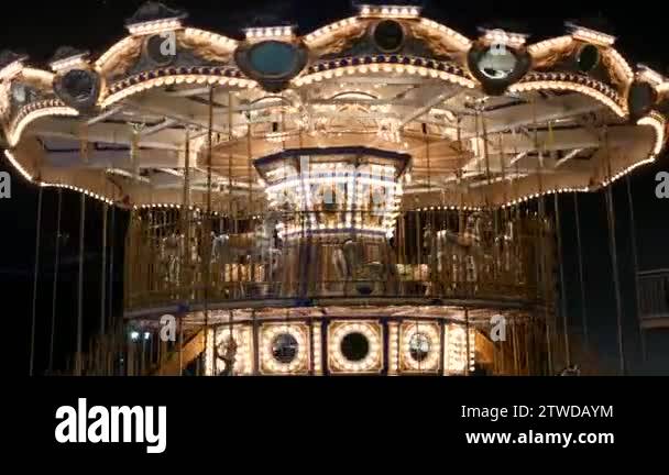 Illuminated merry go round in park. Brightly illuminated roundabout ...