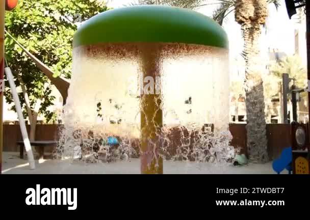 playground by the pool, with fountains. Waterfall from a fountain ...