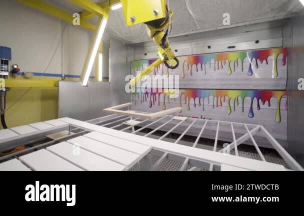Industrial robotic arm paint frame. Action. Automated robotic arm ...