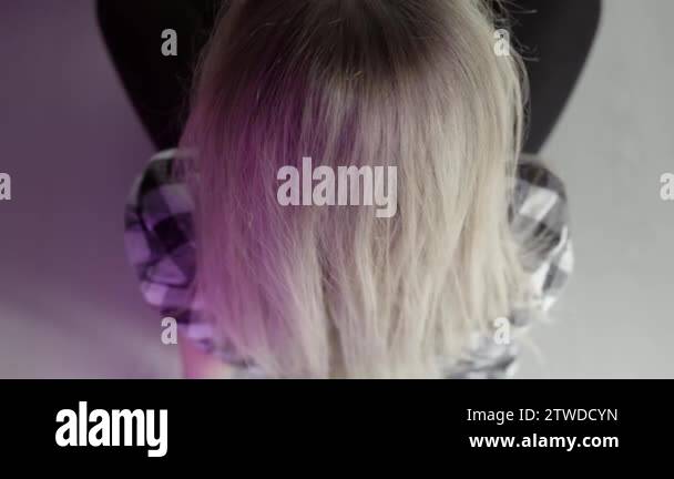 Young woman looks tilting back her head. Action. Young attractive woman ...