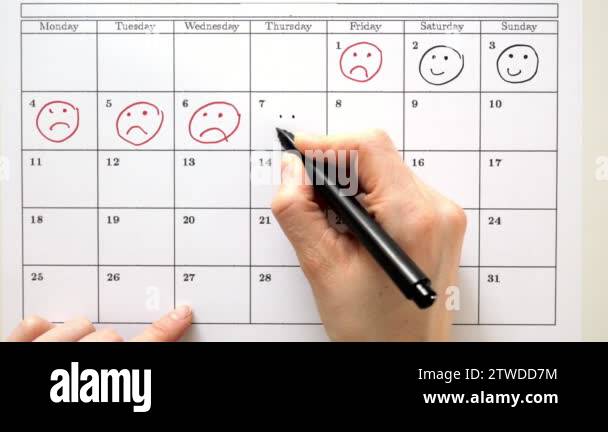 Sign the day in the calendar with a pen, draw a smile Stock Video ...