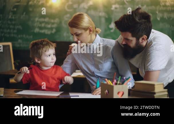 Family is doing happy activities. Parents are teaching drawing child ...