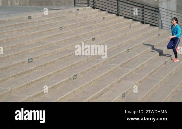 two girls tracing together on city concrete stair. healthy lifestyle ...