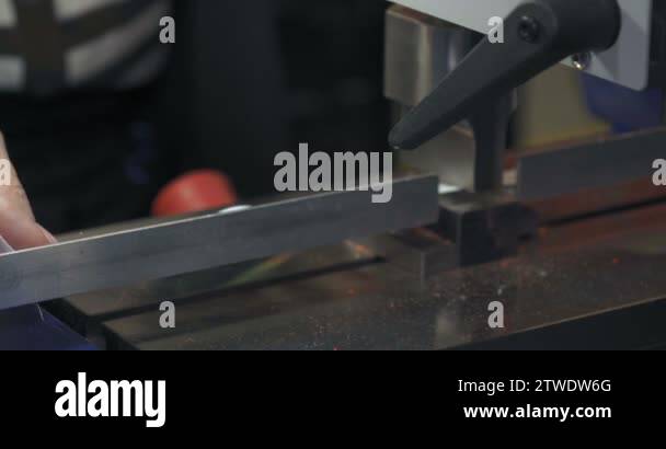 In a slow motion video in a garment factory, women press (cut) various ...