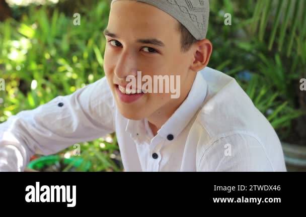Happy Arabic Muslim Young Man Looking At Camera. Young Muslim boy learn ...