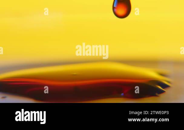 Red blood drops fall on liquid surface looking like a small puddle An ...