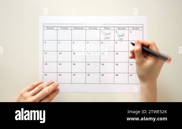 Sign the day in the calendar with a pen, draw a good bad day Stock ...