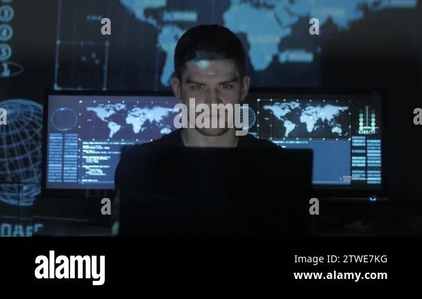 Male Hacker Programmer Working At Computer While Blue Code Characters