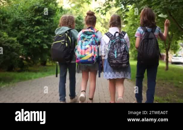 Classmates go to school on the avenue. First school day, back to school ...
