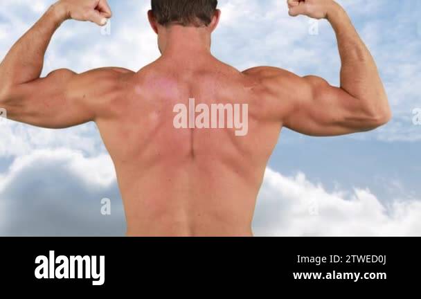 Rear view of a male bodybuilder flexing his back muscles with a sky ...