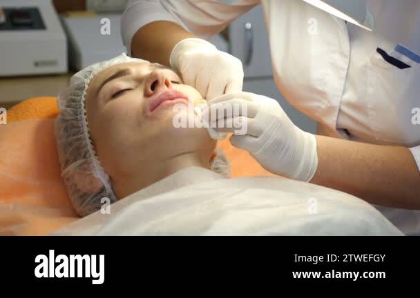 Beauty clinic. Beautician hands in gloves making face aging injection ...