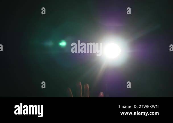 dark silhouette of human male hand with raised fingers in spotlight or ...