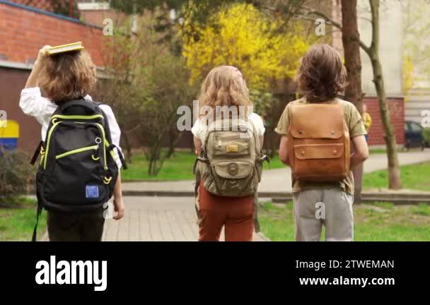 Schoolchildren return from school. Back to school. Three children, two ...