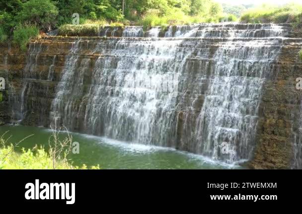 Gorgeous slow motion view of water pouring down the rocky stepped ...