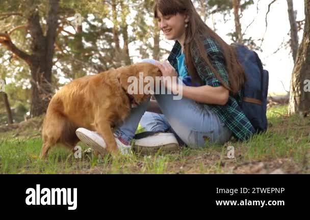 Sexy breeder girl is training a dog. Woman traveler with a dog ...
