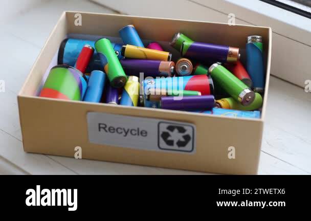 Battery Collection Box. Waste sorting. Young man places used batteries ...
