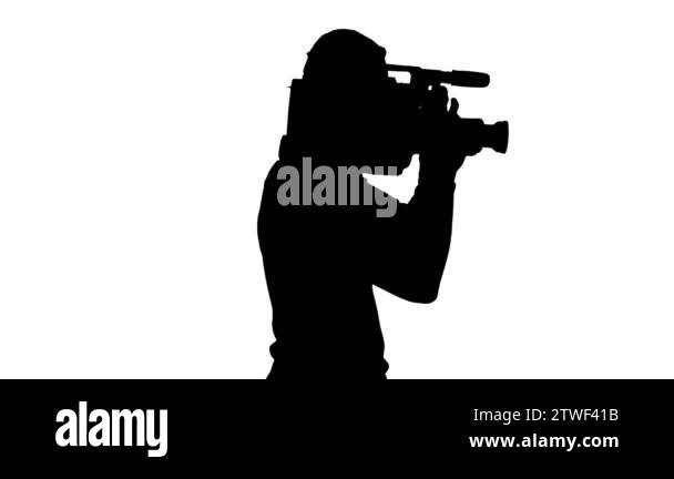 Cameraman steps with the camera on his shoulder. White background ...
