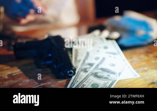 Gun, drugs and money. Drug dealer stacks the heroin filled bags Stock ...