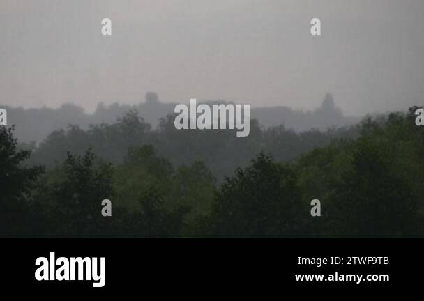 Storm and shower with lightning. Heavy rain with black clouds and wind ...