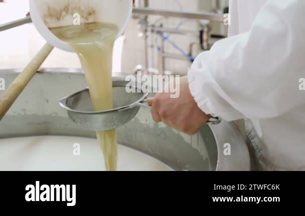 filtering the whey in the cauldron- Dairy cheese factory Stock Video ...