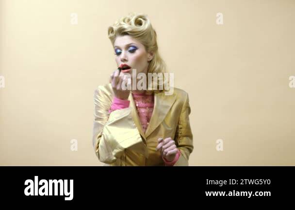 Beautiful brunette pin-up retro woman paints lips. Pretty pin up woman ...