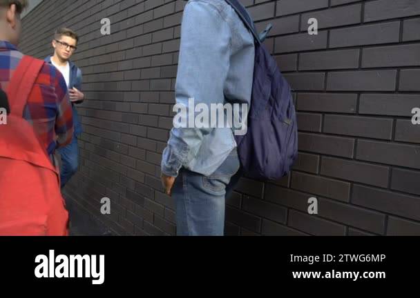 Hooligans stopping weak boy in school backyard, bullying, provoking ...