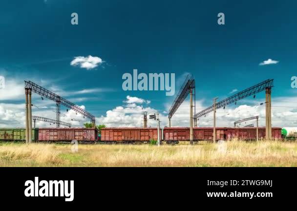 Freight railroad hopper train at the background clouds. Timelapse 4K ...