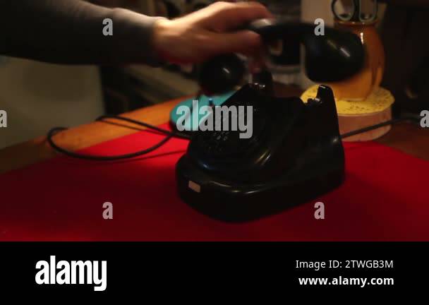 Dialing with an retro rotary phone, man in the office dials the old ...