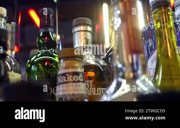 Close-up of variety of alcohol in bar. Frame. Colorful glass bottles ...