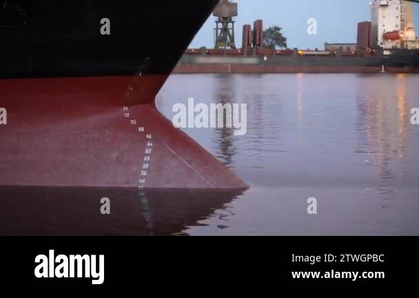 Day to night timelapse of submerged under the cargo weight freighter ...