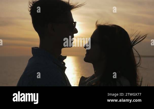 Young people look at each other romantically on the Black Sea shore at ...