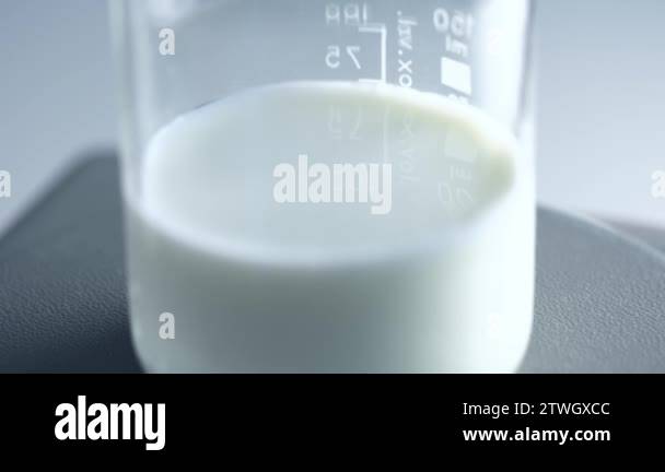 Laboratory experiments. Reagent and milk mixing reaction Stock Video ...
