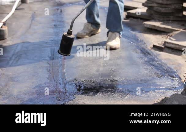 Roofing installation resin with propane blowtorch using a gas burner ...