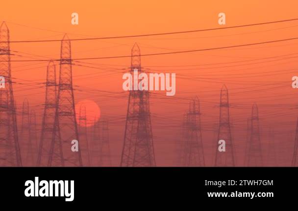camera moving sideways looking at electricity pylons during sunset ...