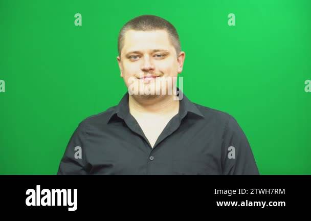 Young man posing. The man makes a silent sign of agreement and ...