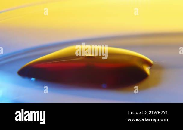 Metallic needle pulls in red blood from a glassy surface in a medical ...