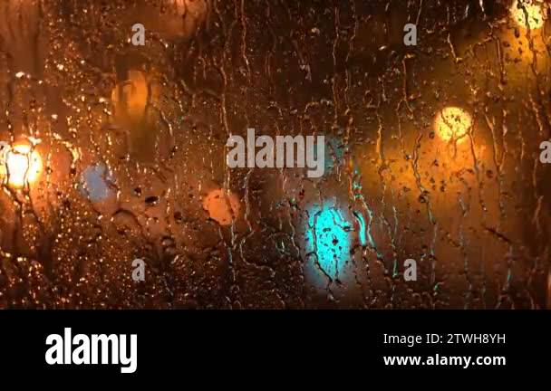 Night City Through Rainy Window. Raindrops On Glass Window Against ...