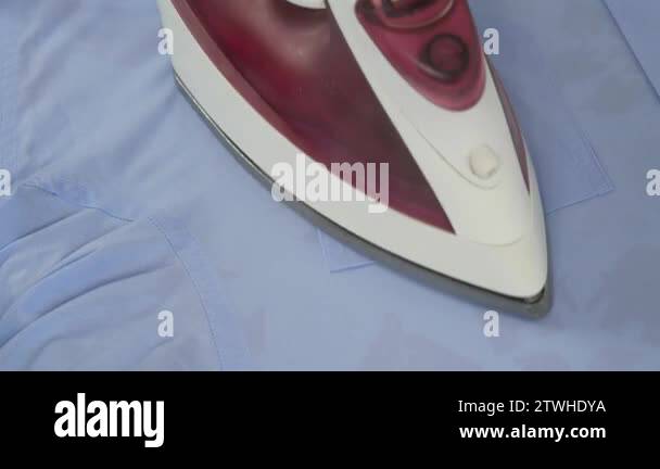 Close Up Man Hands Smooth a Blue Shirt with Iron (Ultra High Definition ...