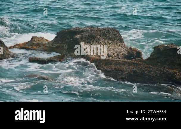 The Turkish seashore with cliffs and stones in Alanya in summer in slo ...
