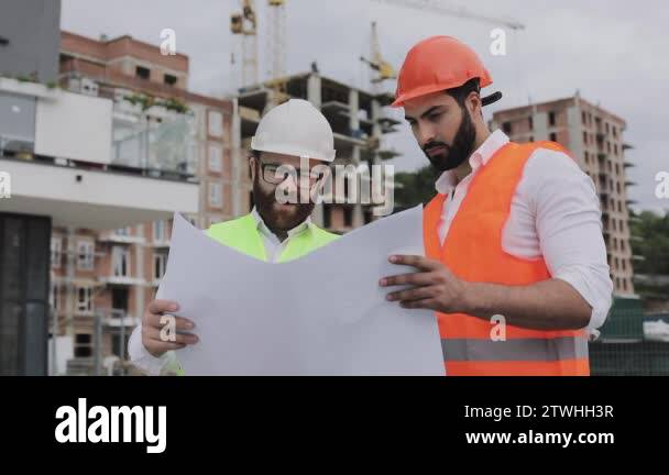 Architect expert engineers talking and analyze design plan standing ...