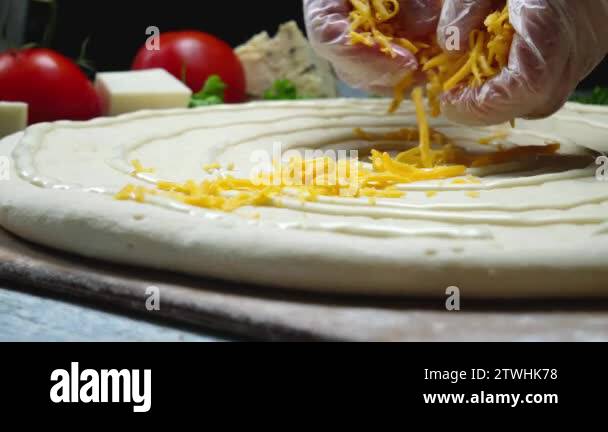 Chef pours cheese on pizza. Frame. Professional chef of Italian cuisine ...