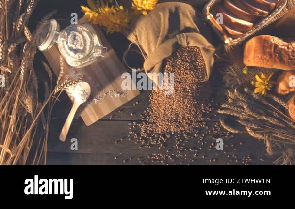 Still life with bread, wheat, flour and flowers.Top view. Horizontal ...