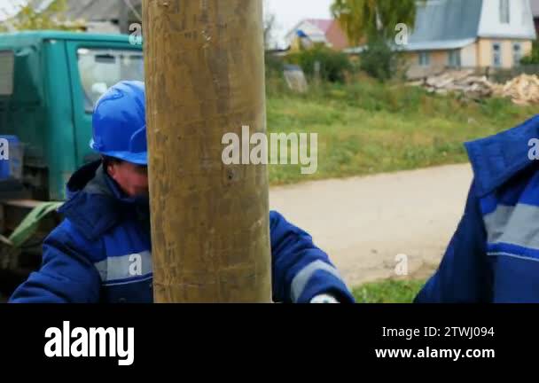 men install electrical pole for village electricity supply Stock Video ...