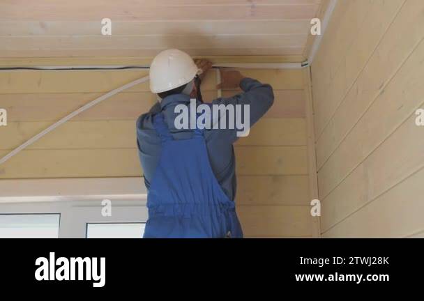 electrical engineer performs installation of electrical wiring in a new ...