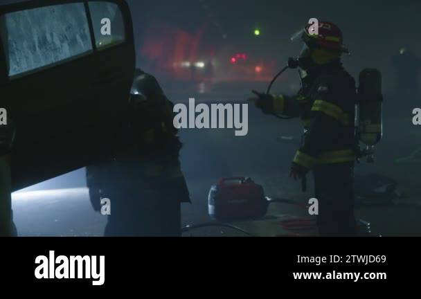 Car accident scene inside a tunnel, firefighters rescuing people from ...