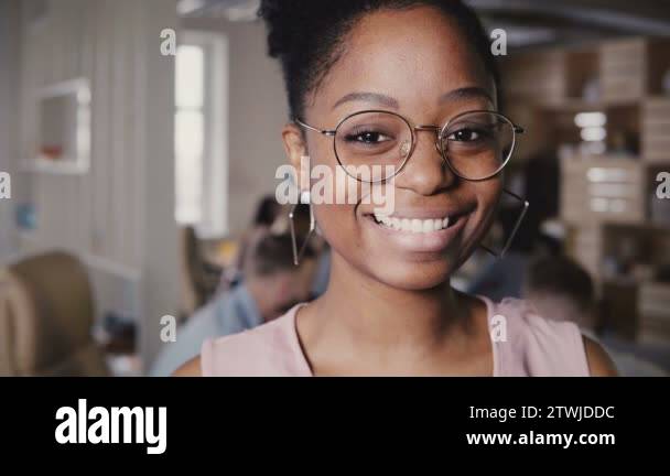 Pretty young African American happy female leader in glasses smiling at ...